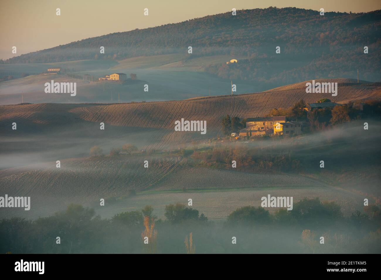 landscape with hills, fog and trees in Tuscany, Italy in autumn at ...