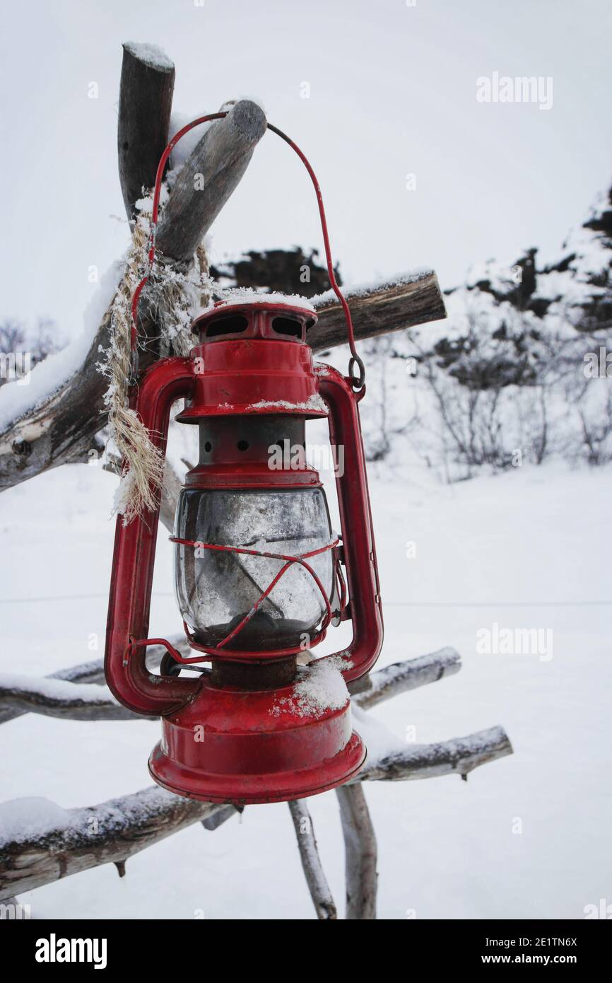 Closeup of a antique ancient old traditional red hand-held lantern ...