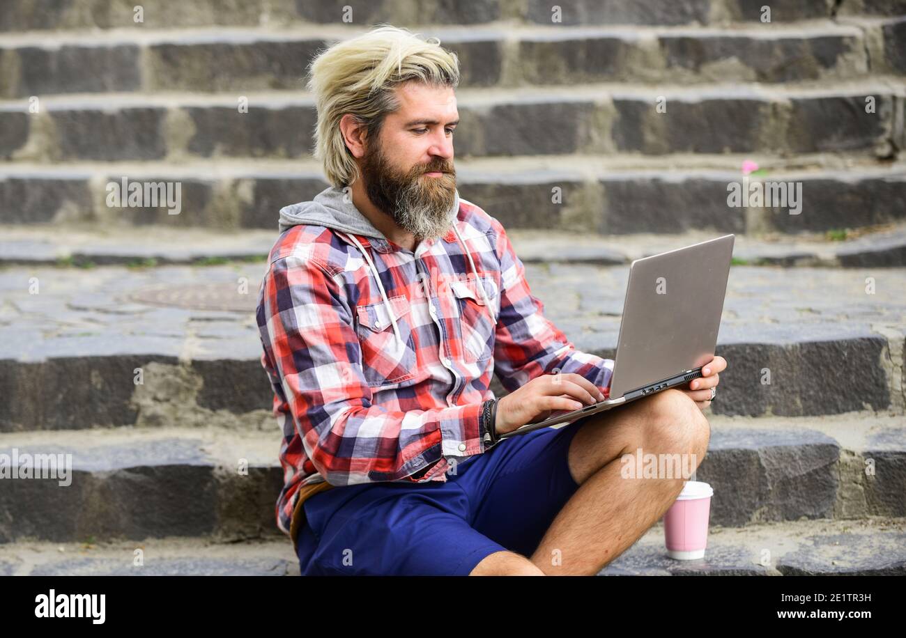 Enjoying student life. Businessman using notebook. take away coffee ...
