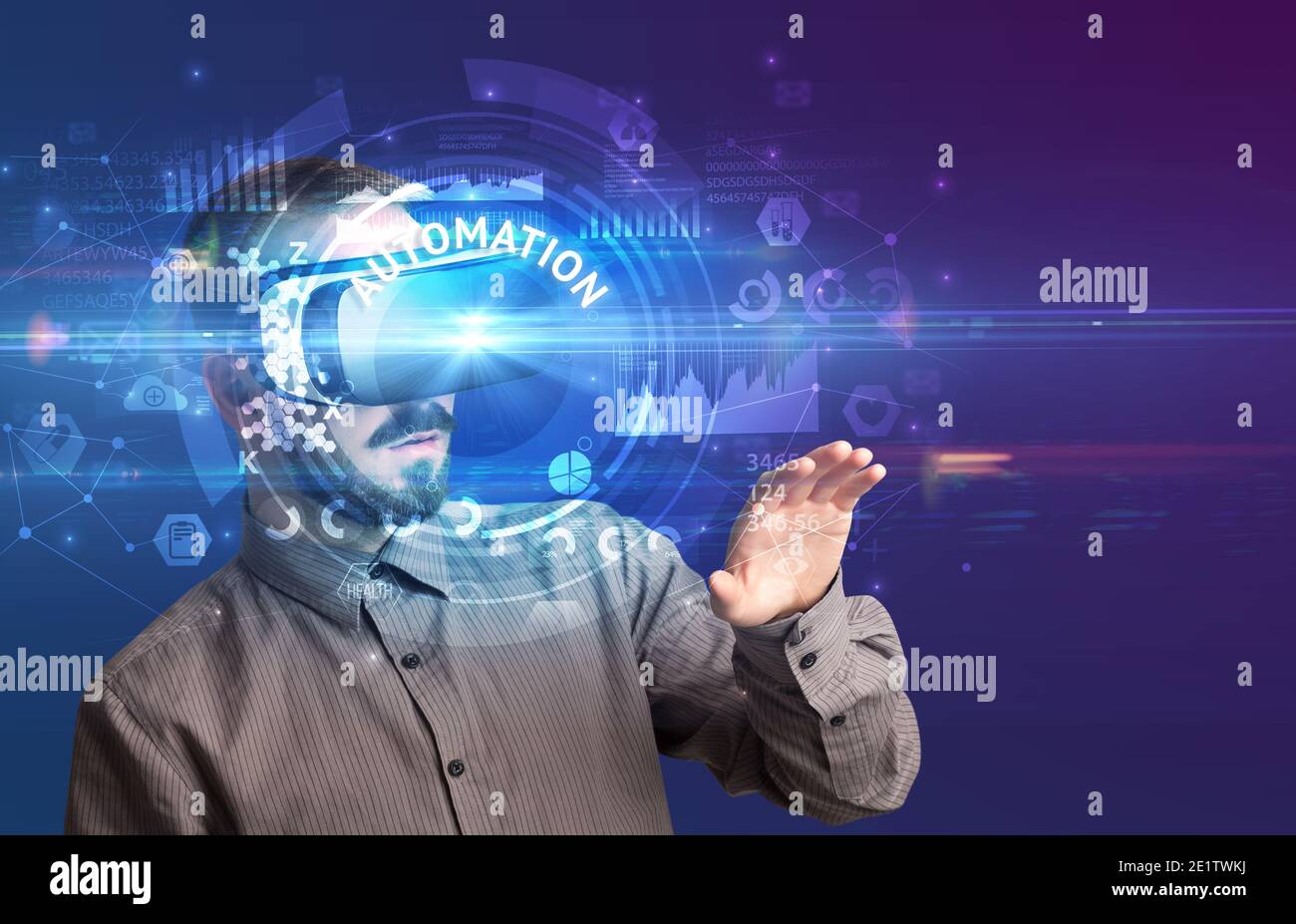 Businessman looking through Virtual Reality glasses with AUTOMATION ...