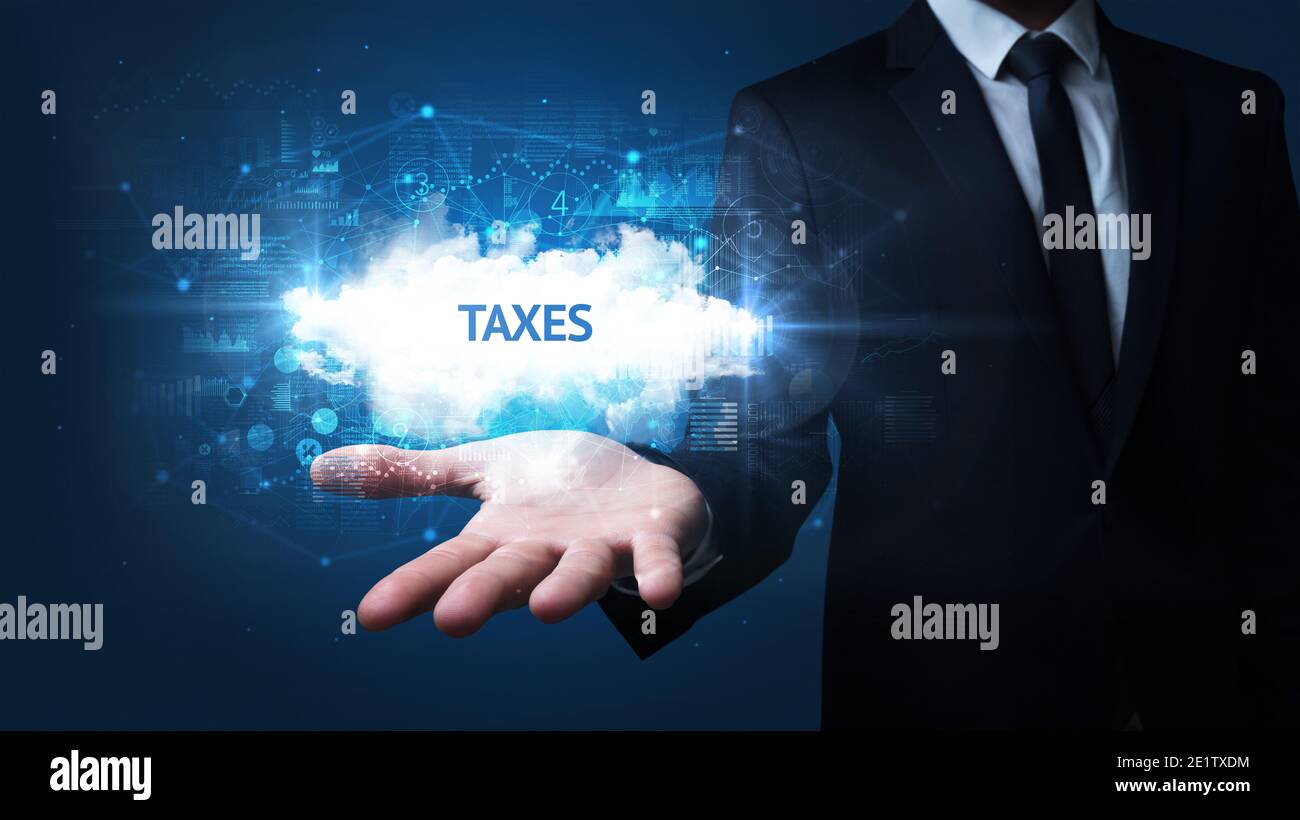 Hand of Businessman holding TAXES inscription, successful business ...