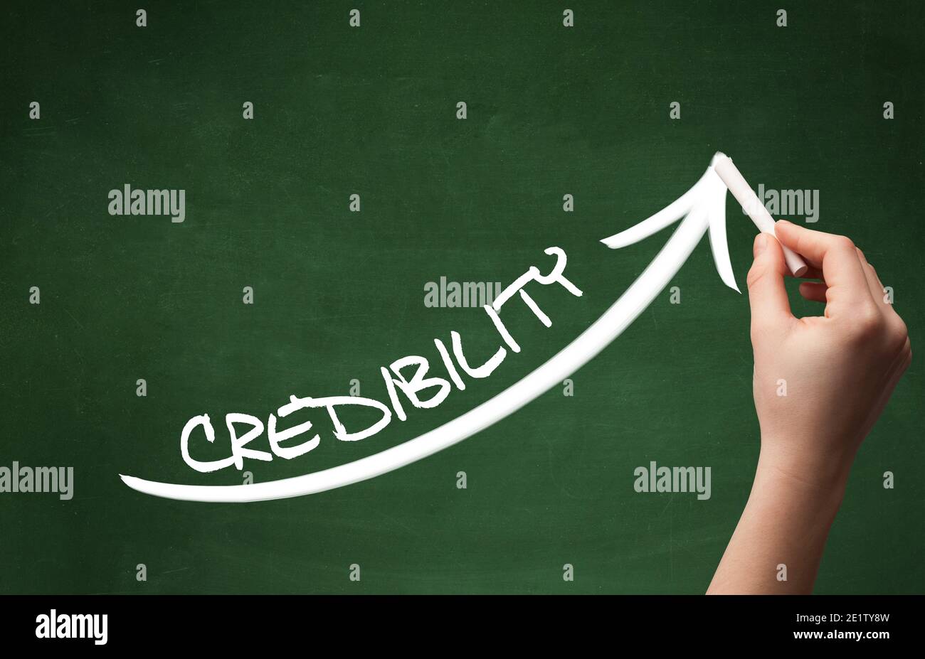 Hand drawing CREDIBILITY inscription with white chalk on blackboard ...