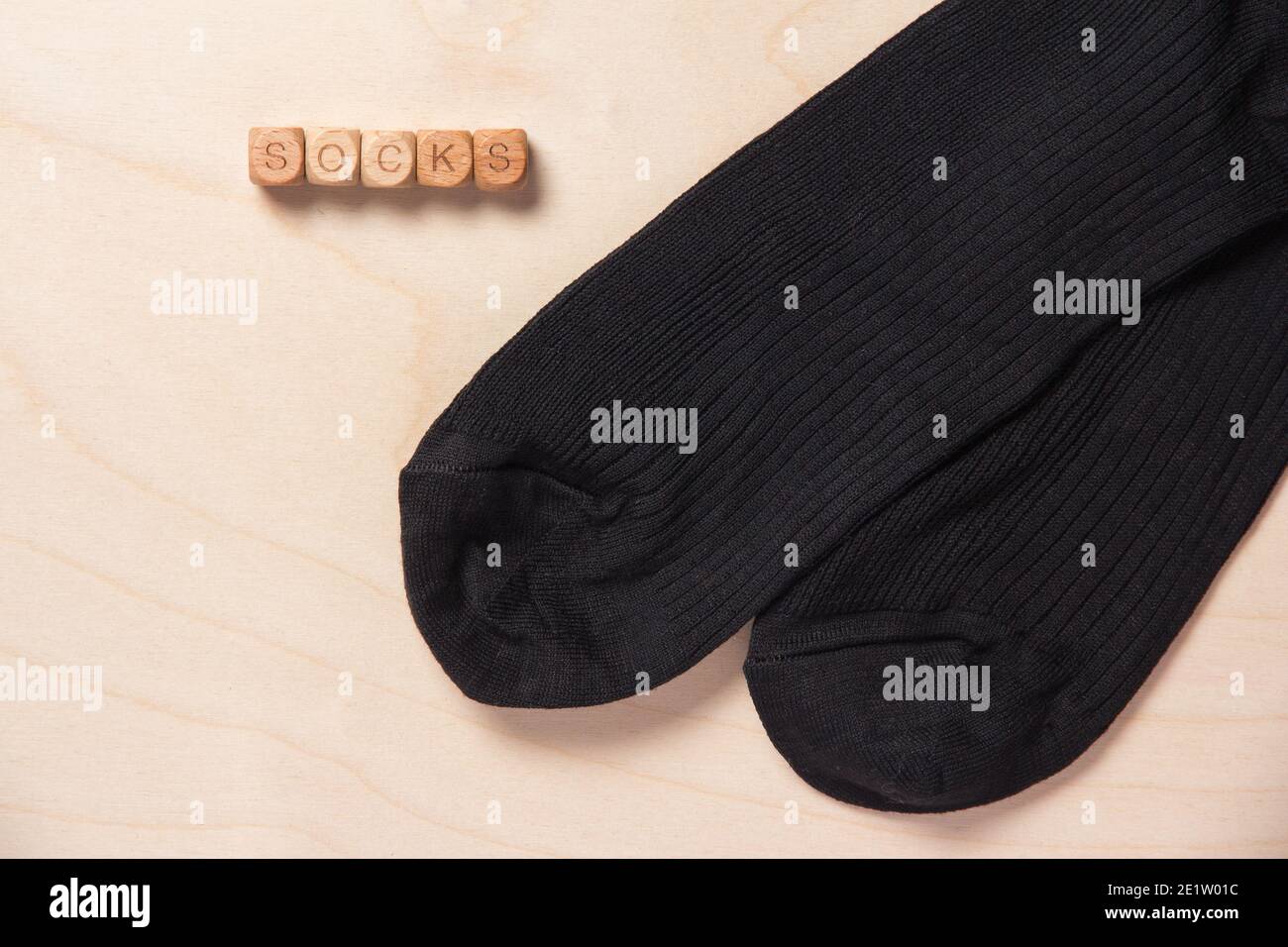 Word denoting socks consists of wooden cubes with letters. Wooden cubes ...