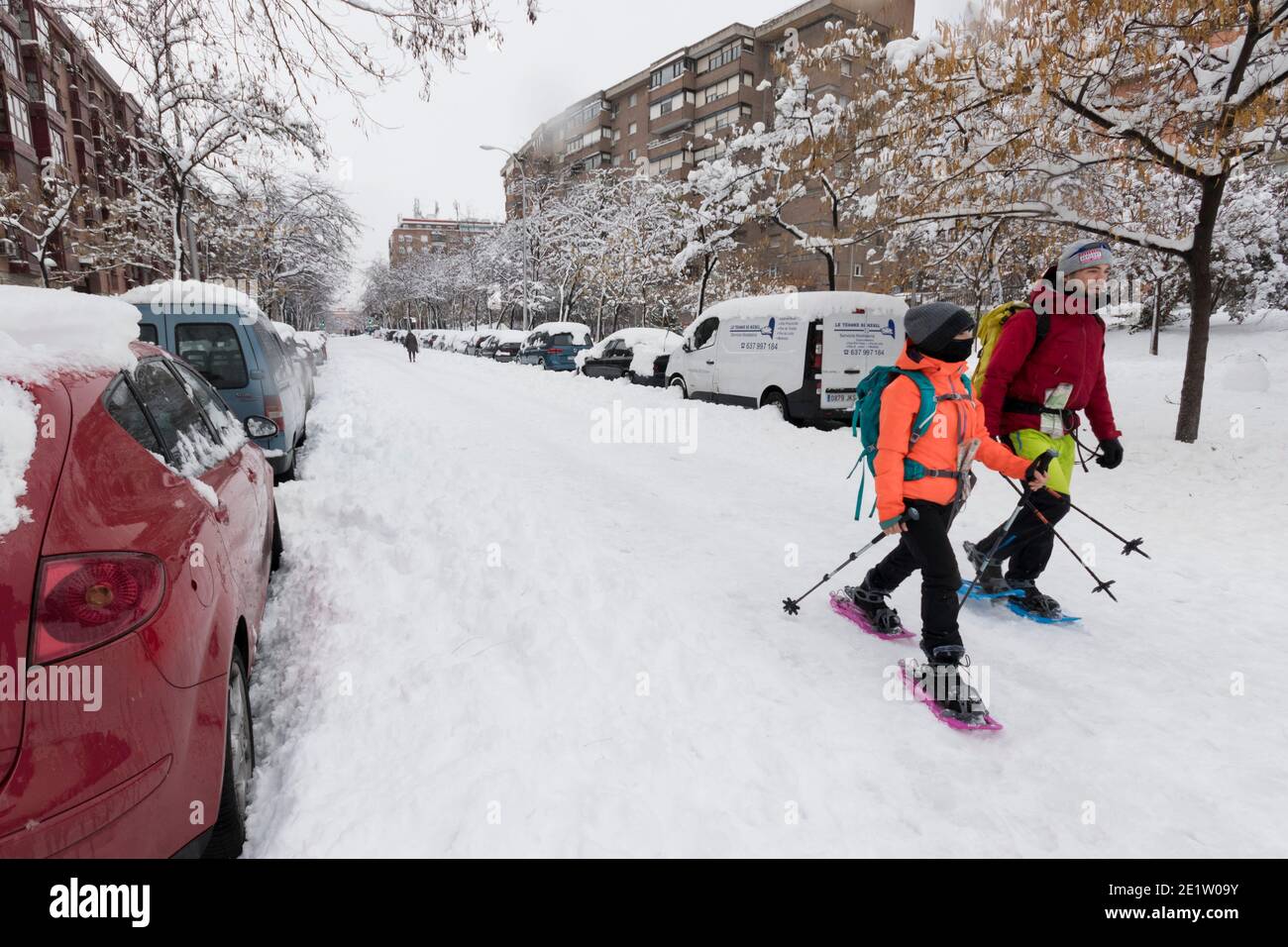 Two people walking in the middle of the street with snow rackets, 2021 ...