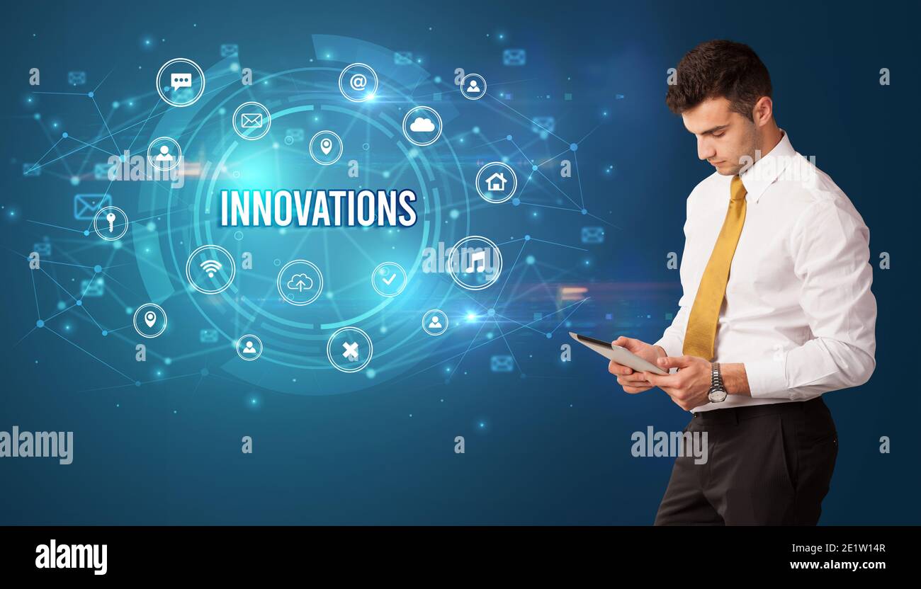 Businessman thinking in front of technology related icons and ...