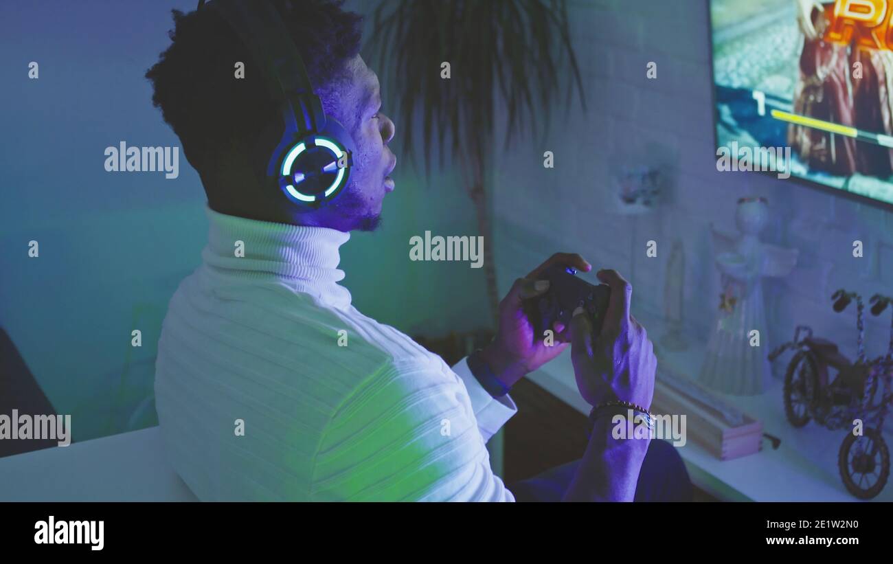 African black man gamer playing video games using joystic controller ...