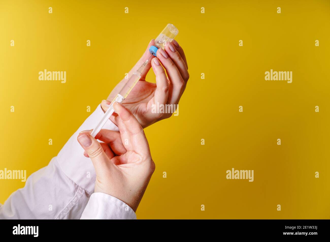 Close up on hand of unknown caucasian woman doctor holding syringe with ...