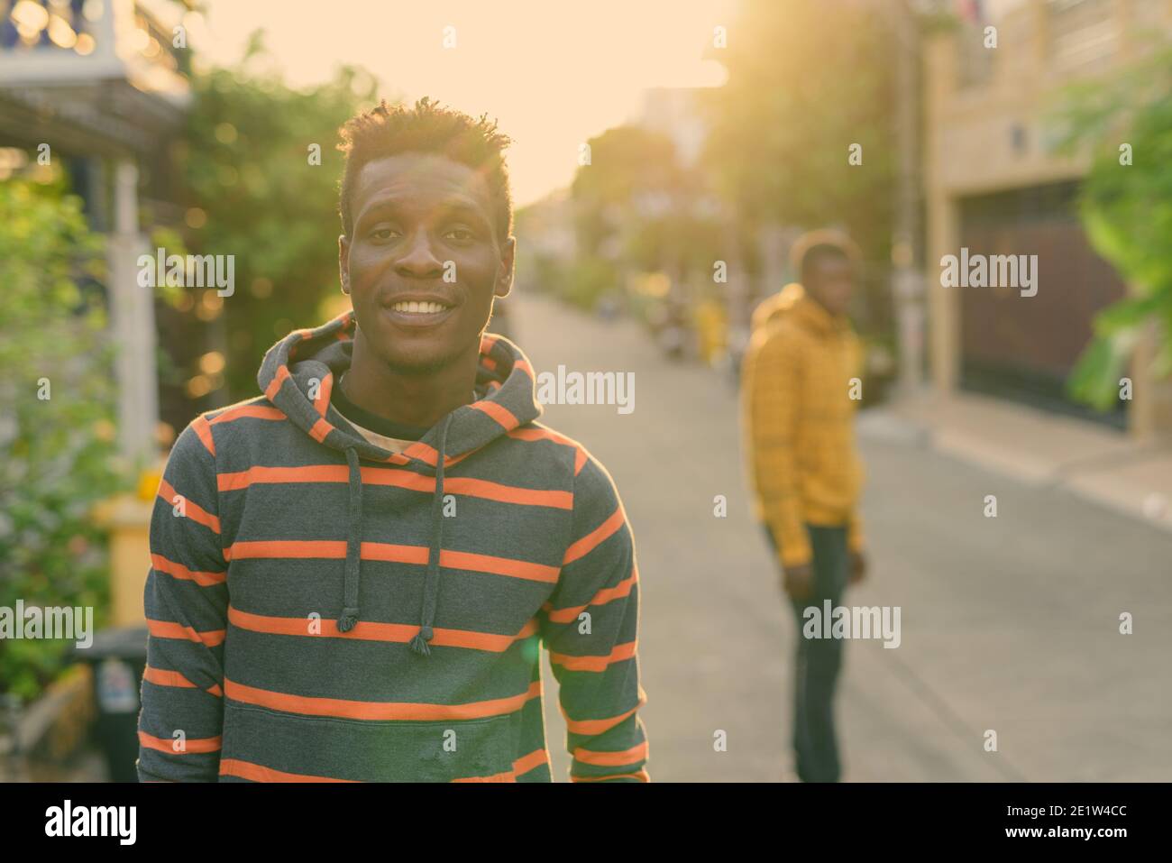 Young happy slim black African man smiling with young black African man ...