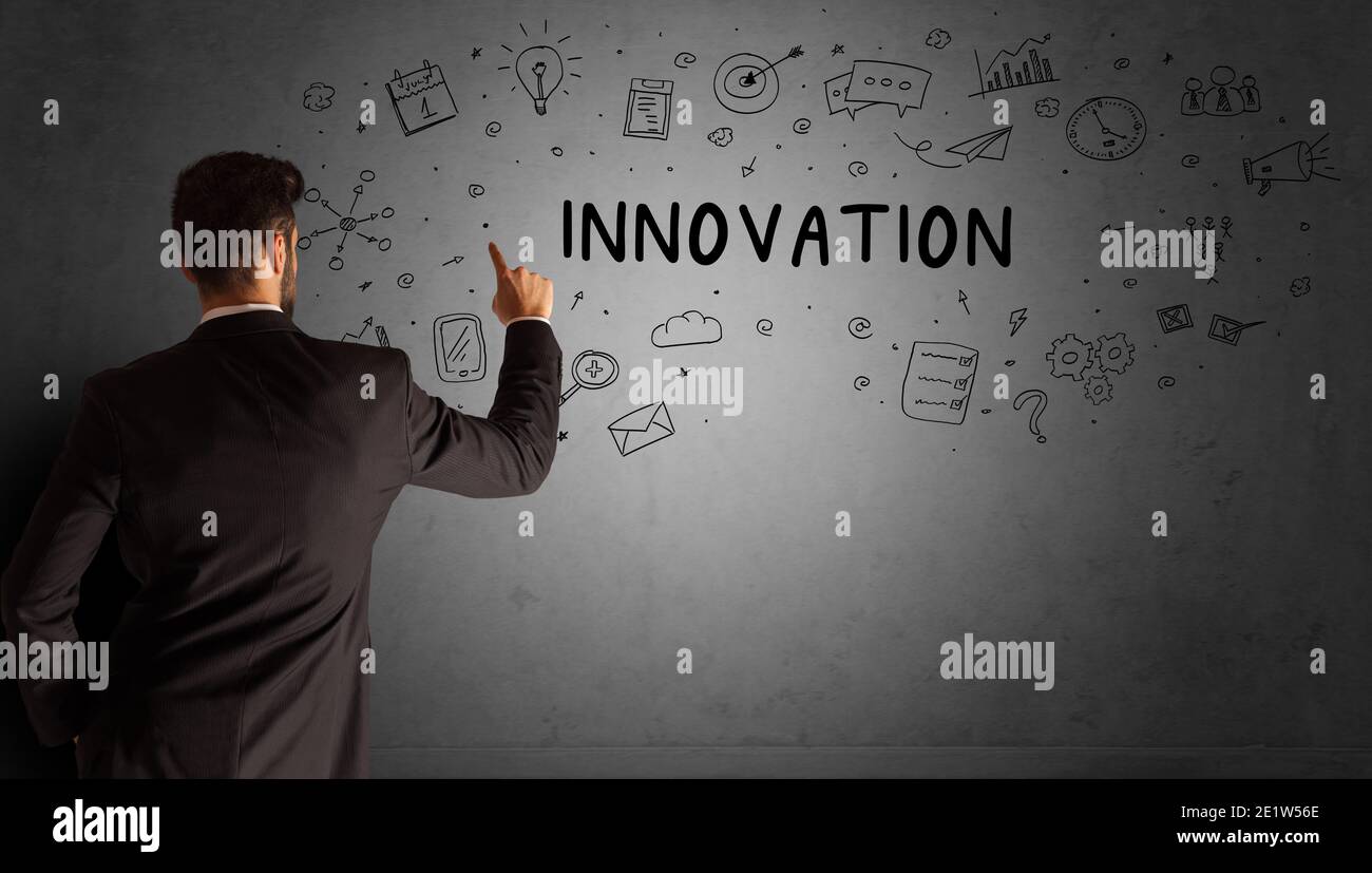 businessman drawing a creative idea sketch with INNOVATION inscription ...
