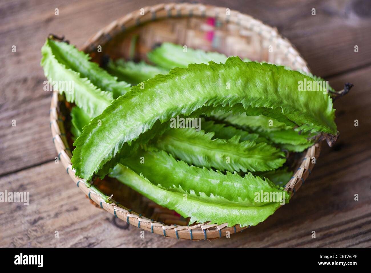 wing bean on basket and wooden table background, young winged beans ...