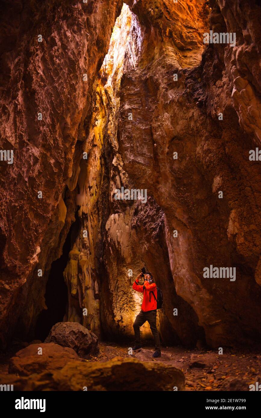 man in cave, Explorer photographer exploration with ray of light in ...