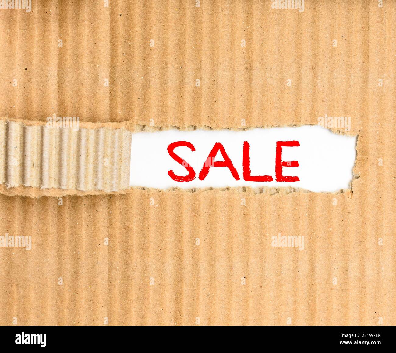 Word Sale written, corrugated torn cardboard background on white paper ...