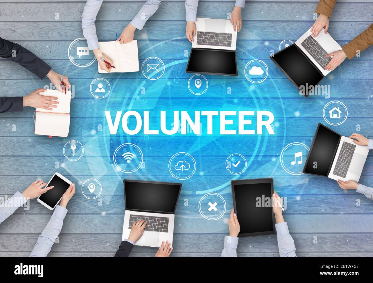 Group of people having a meeting with VOLUNTEER insciption, social ...