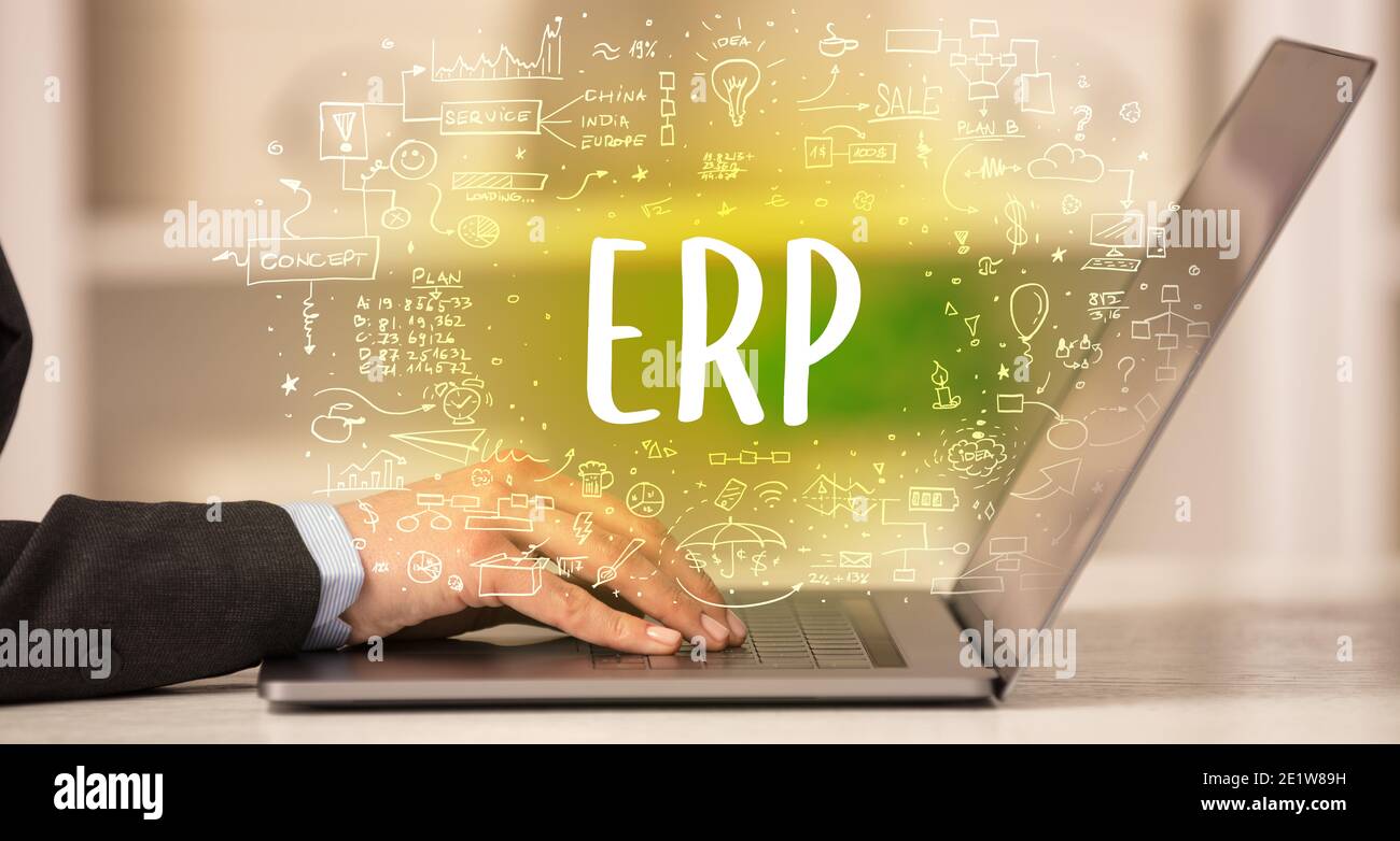 hand working on new modern computer with ERP abbreviation, modern ...