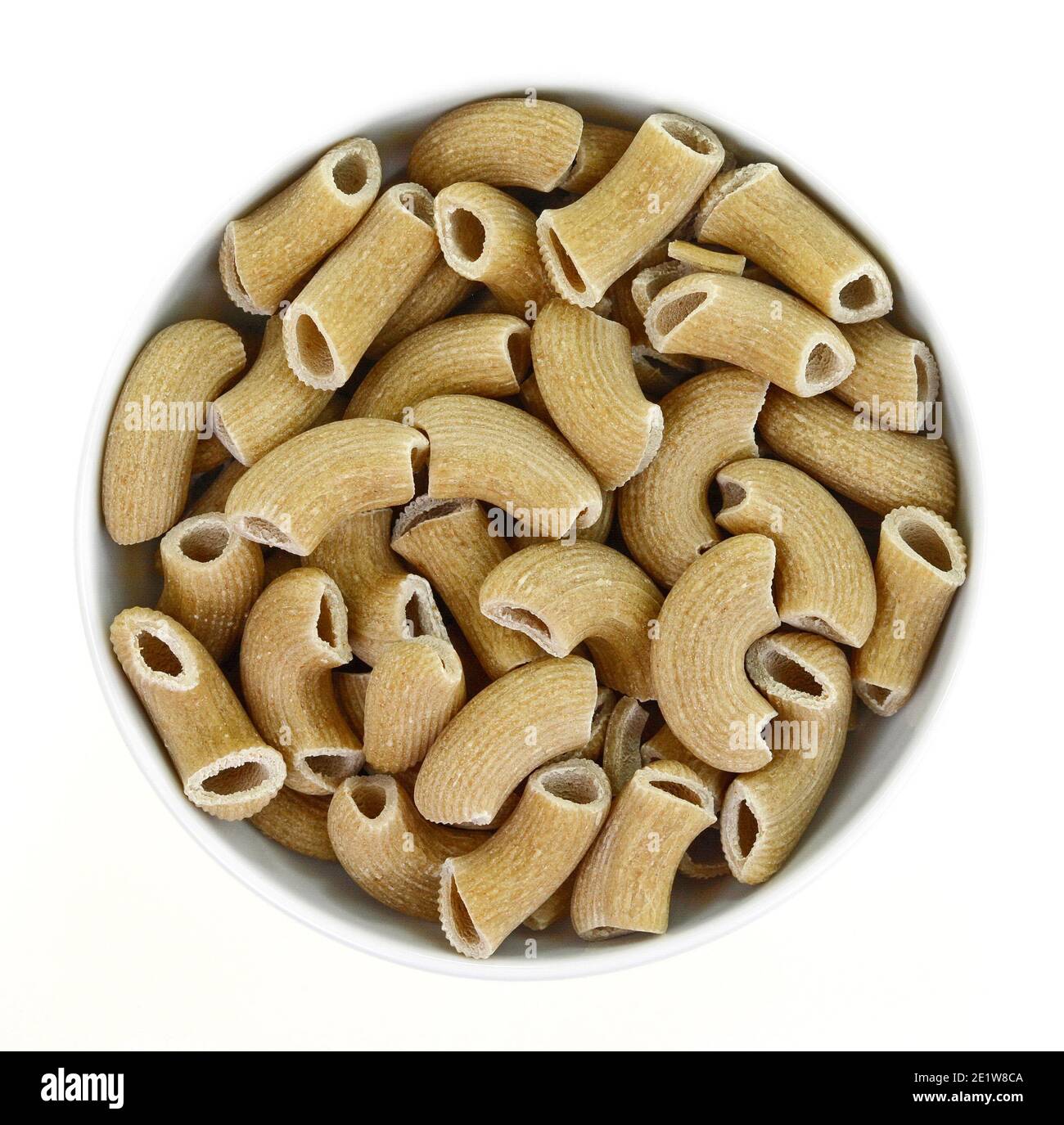 Rustic rigatoni pasta in a bowl isolated on white background ...