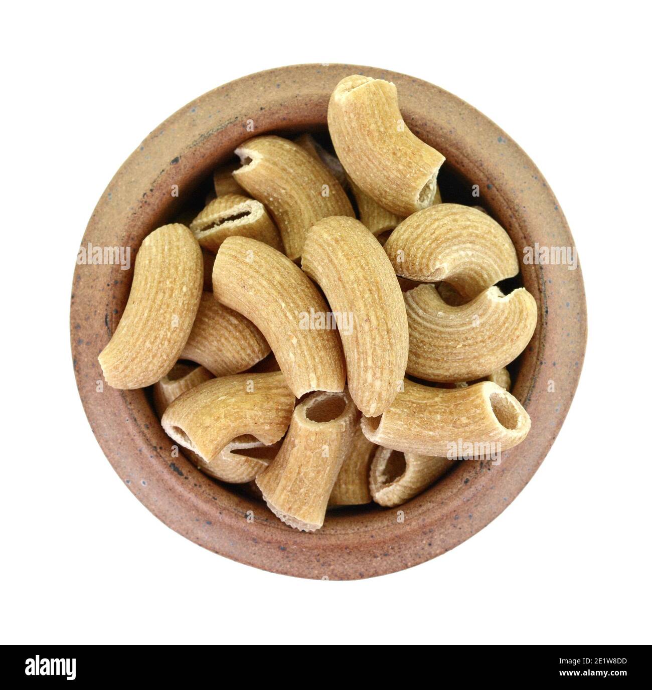Rustic rigatoni pasta in a bowl isolated on white background ...