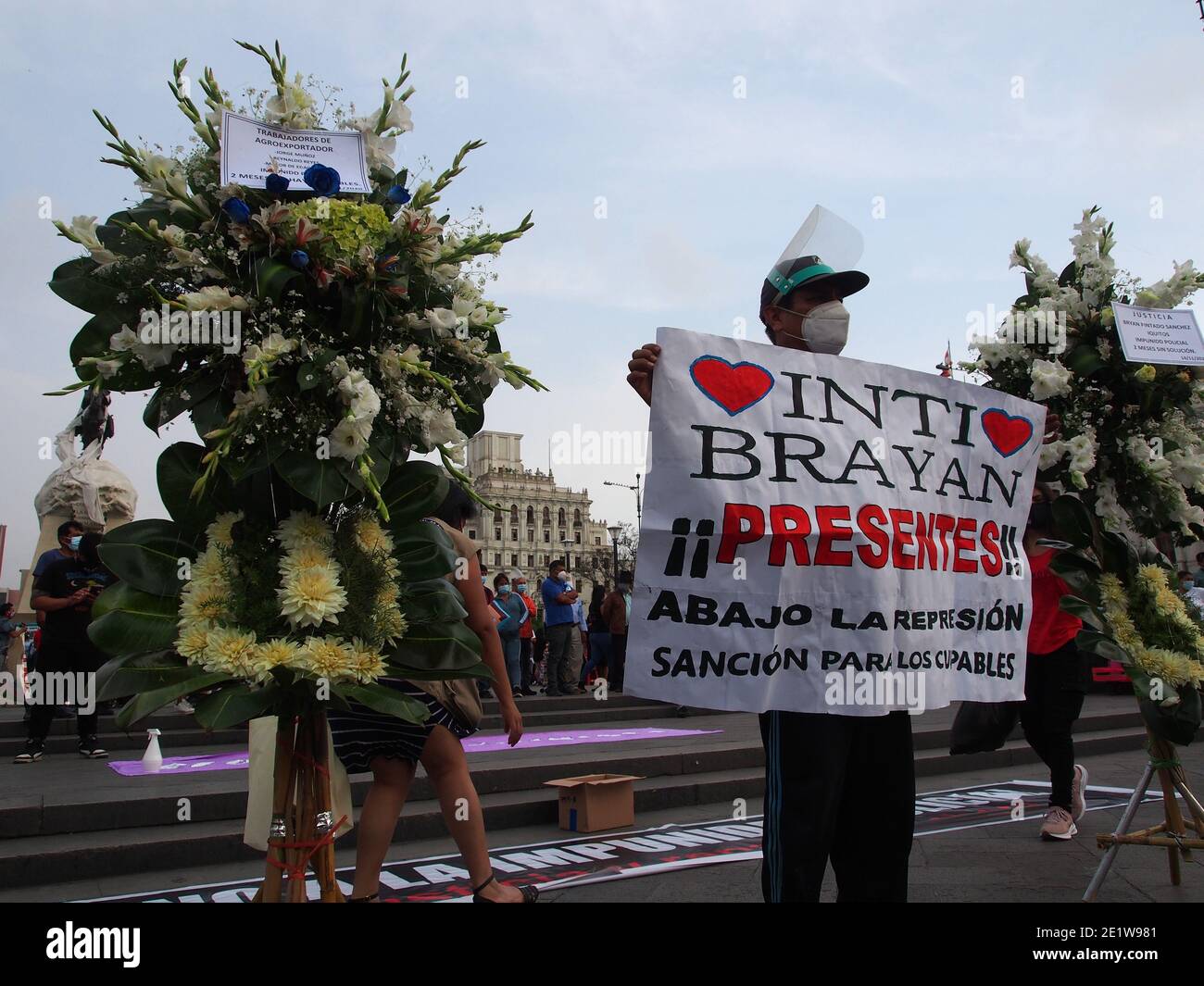 A man carrying a banner with the names of Inti and Bryan, killed in the ...