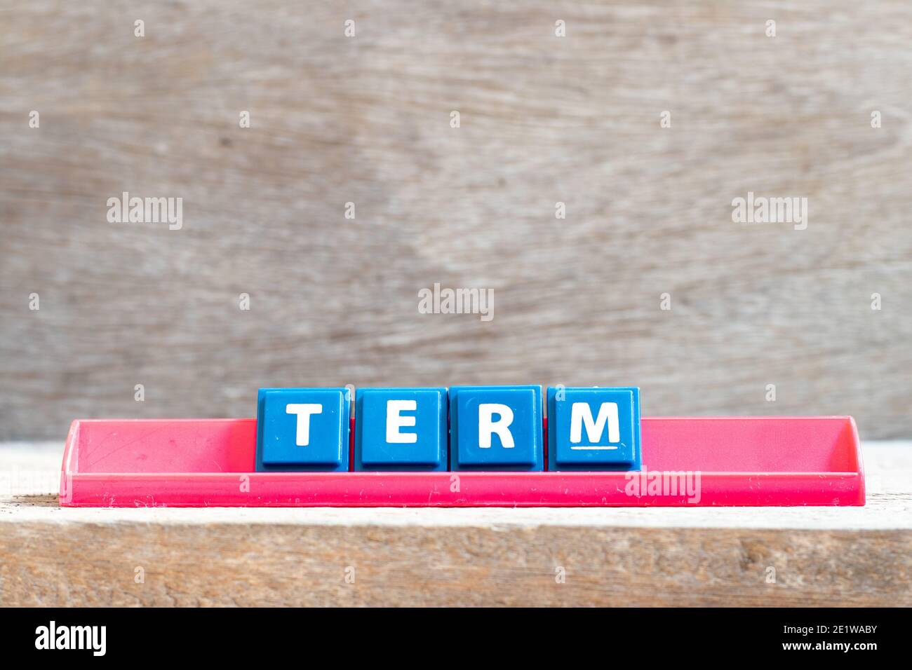 Tile letter on red rack in word term on wood background Stock Photo - Alamy