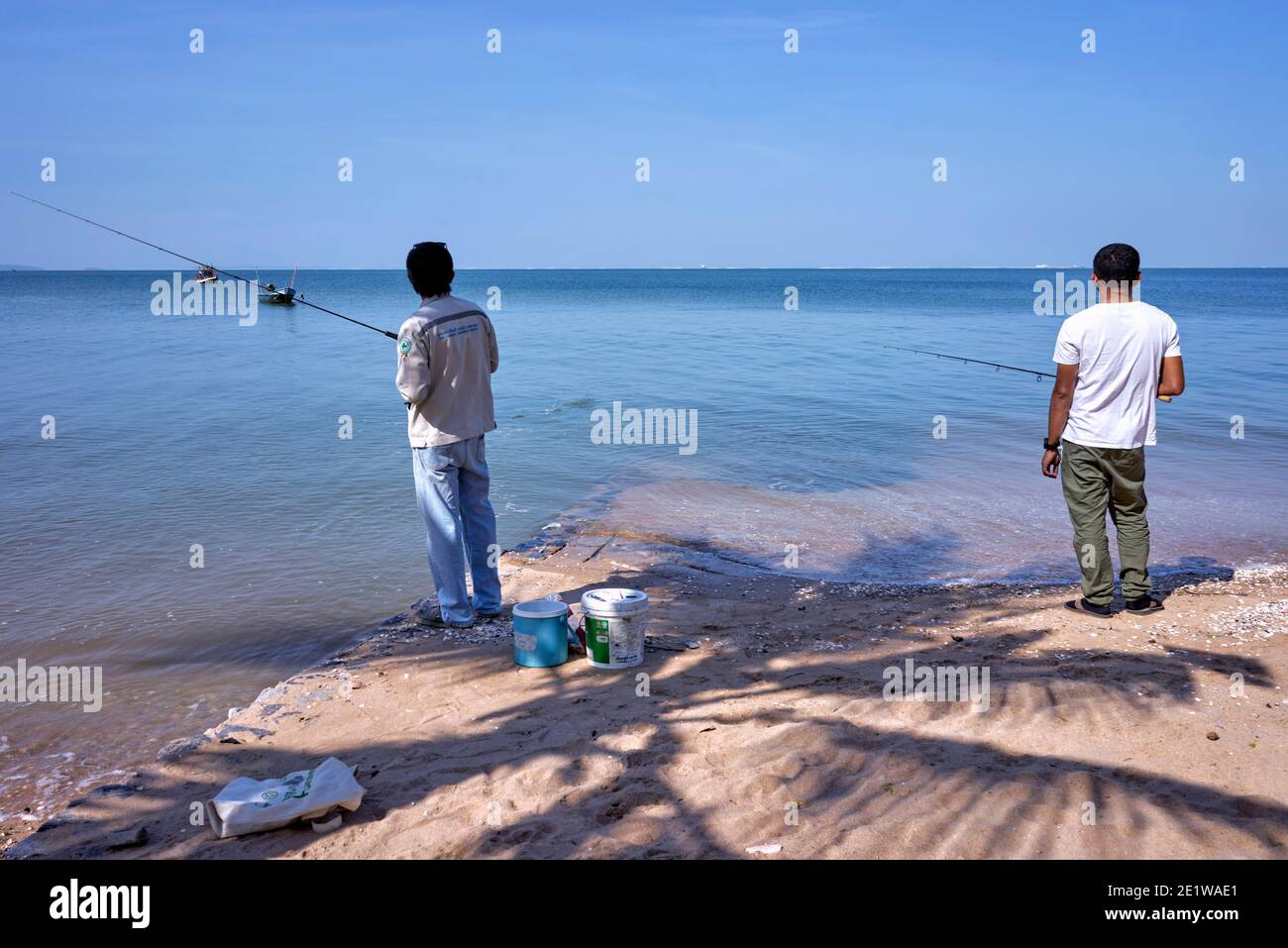 Two men fishing at the beach in Thailand Southeast Asia Stock Photo - Alamy