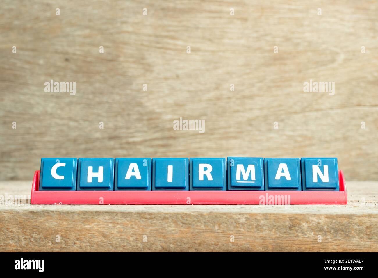 Tile letter on red rack in word chairman on wood background Stock Photo ...