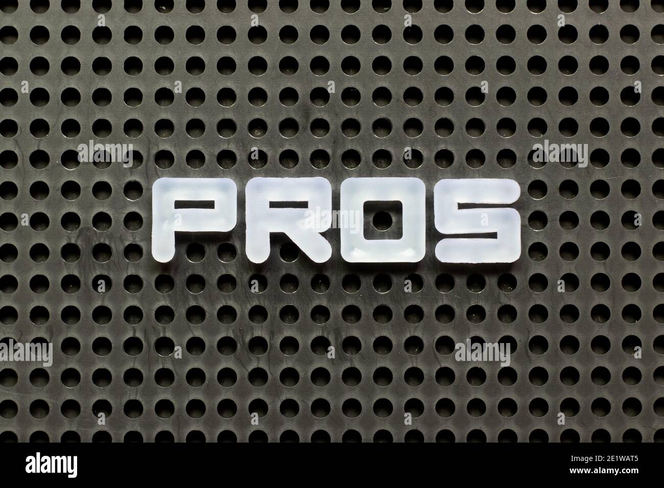 White color letter in word pros on black pegboard background Stock ...