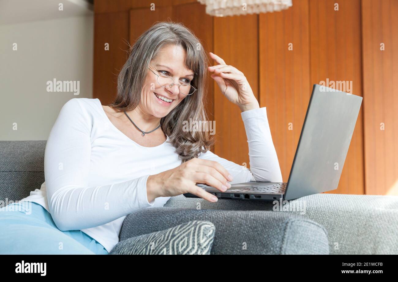 Grandma happy with her new computer as she is using to connect with her ...