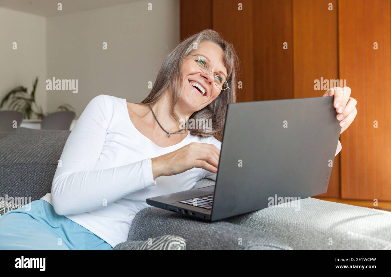 Grandma happy with her new computer as she is using to connect with her ...