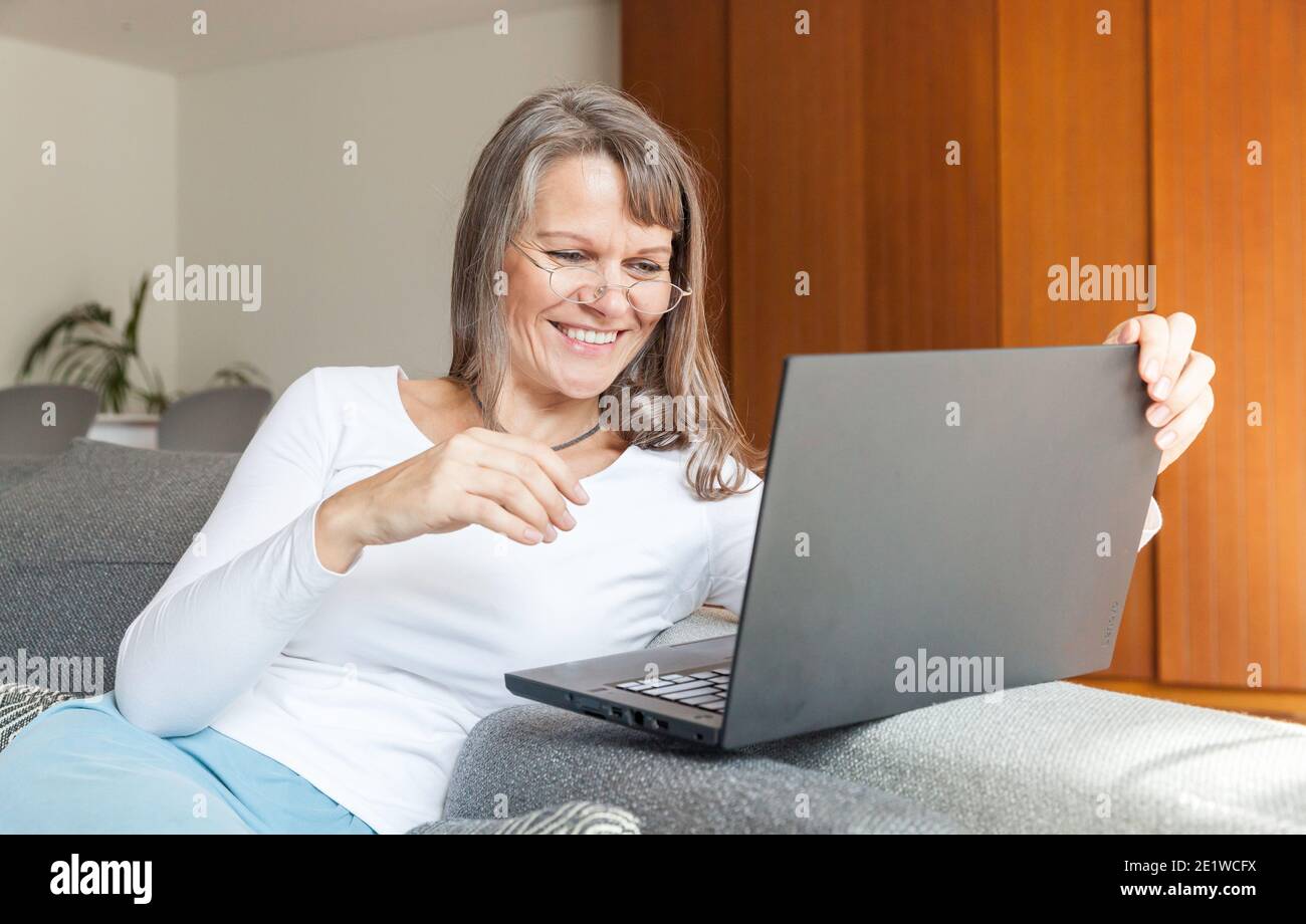 Grandma happy with her new computer as she is using to connect with her ...
