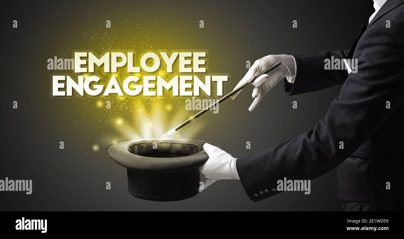 Illusionist is showing magic trick with EMPLOYEE ENGAGEMENT inscription ...