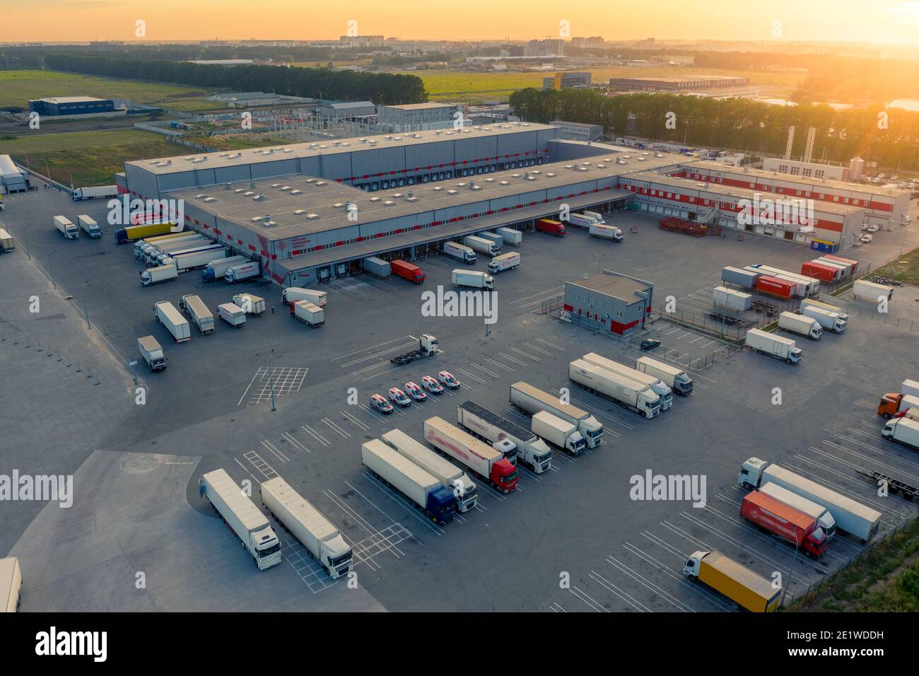 Logistics park with warehouse, loading hub and many semi trucks with ...