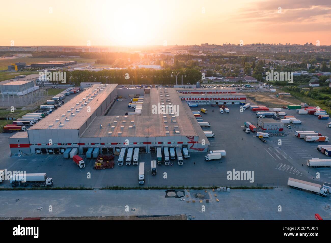 Logistics park with warehouse, loading hub and many semi trucks with ...