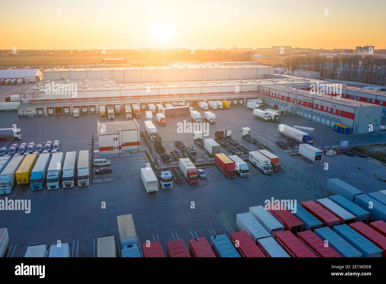 Logistics park with warehouse, loading hub and many semi trucks with ...