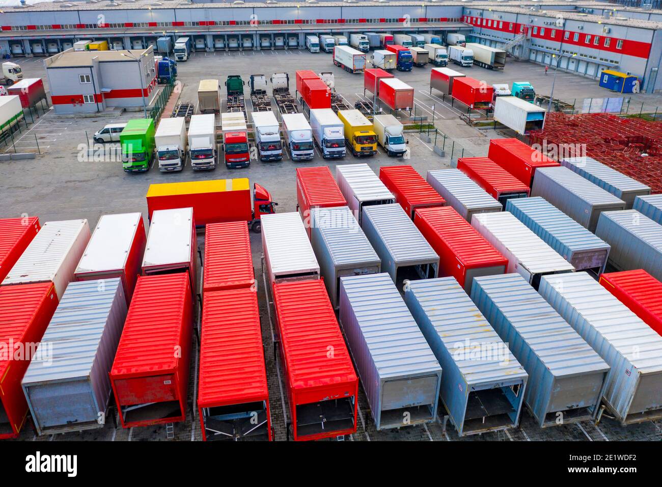 Logistics park with warehouse, loading hub and many semi trucks with ...