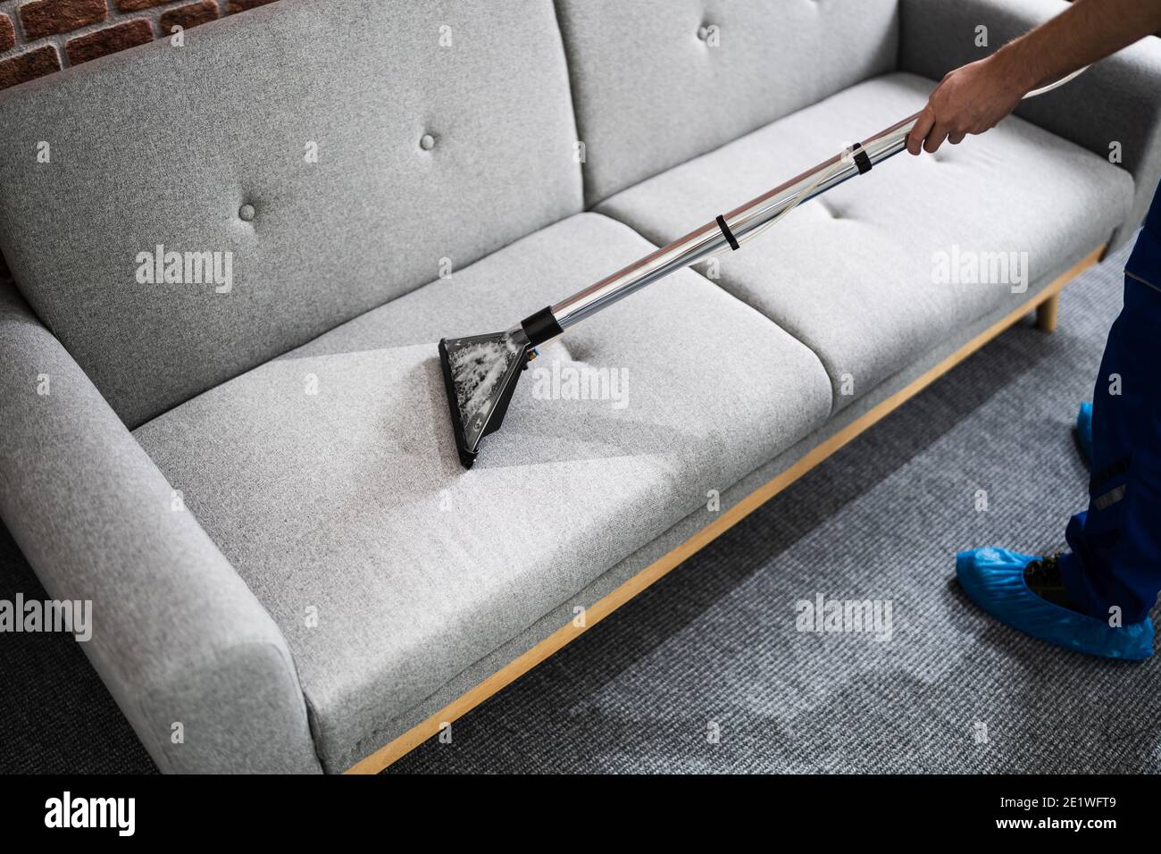 Professional Sofa Cleaning Service Using Vacuum Cleaner Stock Photo - Alamy