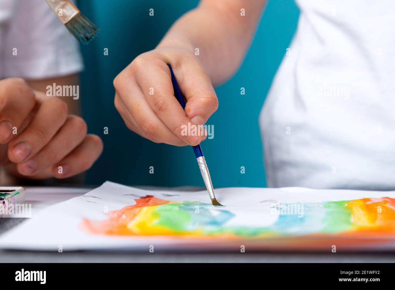 Children's creativity. mom and child son paint watercolor homework for ...