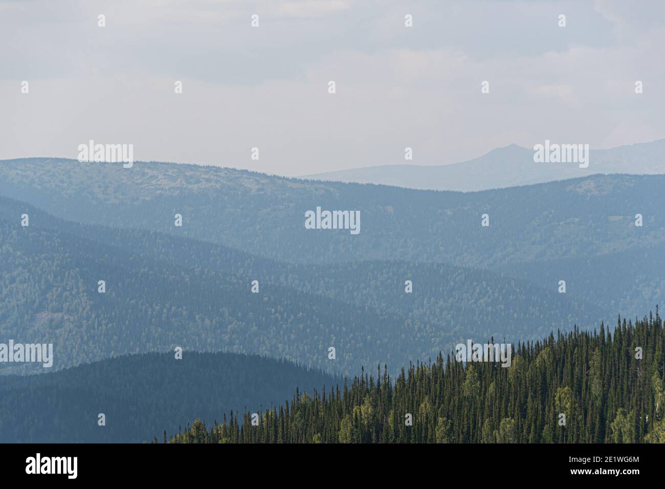 View of calming mountain valley with ridge on horizon. Gentle hills in ...