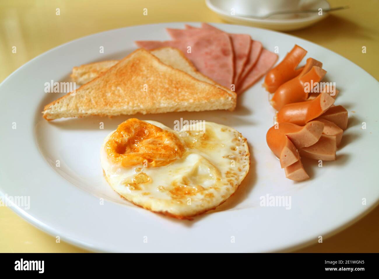 Plate of lovely heart shaped fried egg, sausages and hams with toasts for breakfast Stock Photo ...