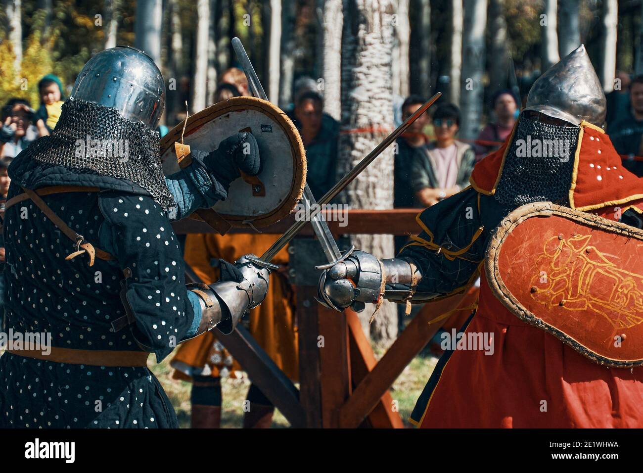 Battle of the red and black knight. Knights with swords and shields, in ...