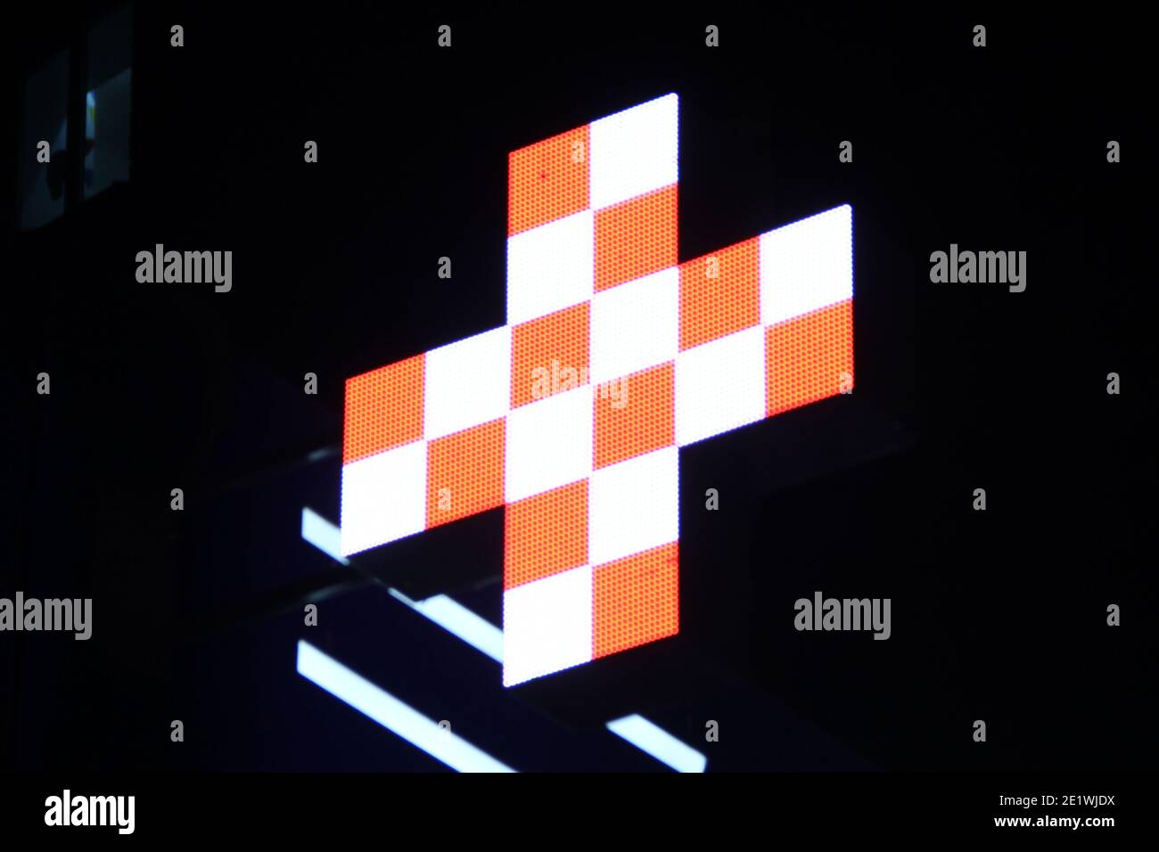 Glowing pixel cross of LED lamps on black background. Cross with a ...