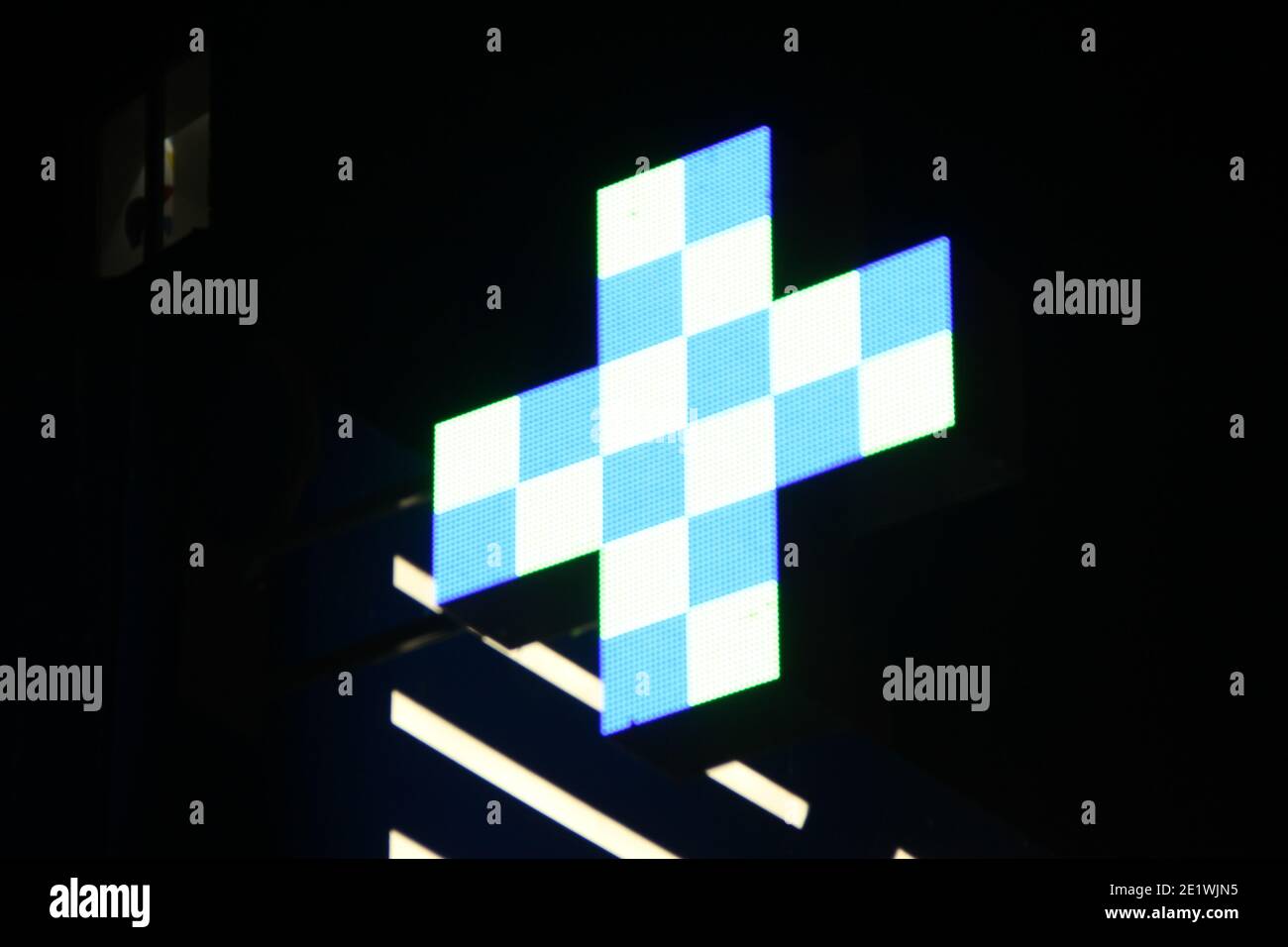 Glowing pixel cross of LED lamps on black background. Cross with a ...