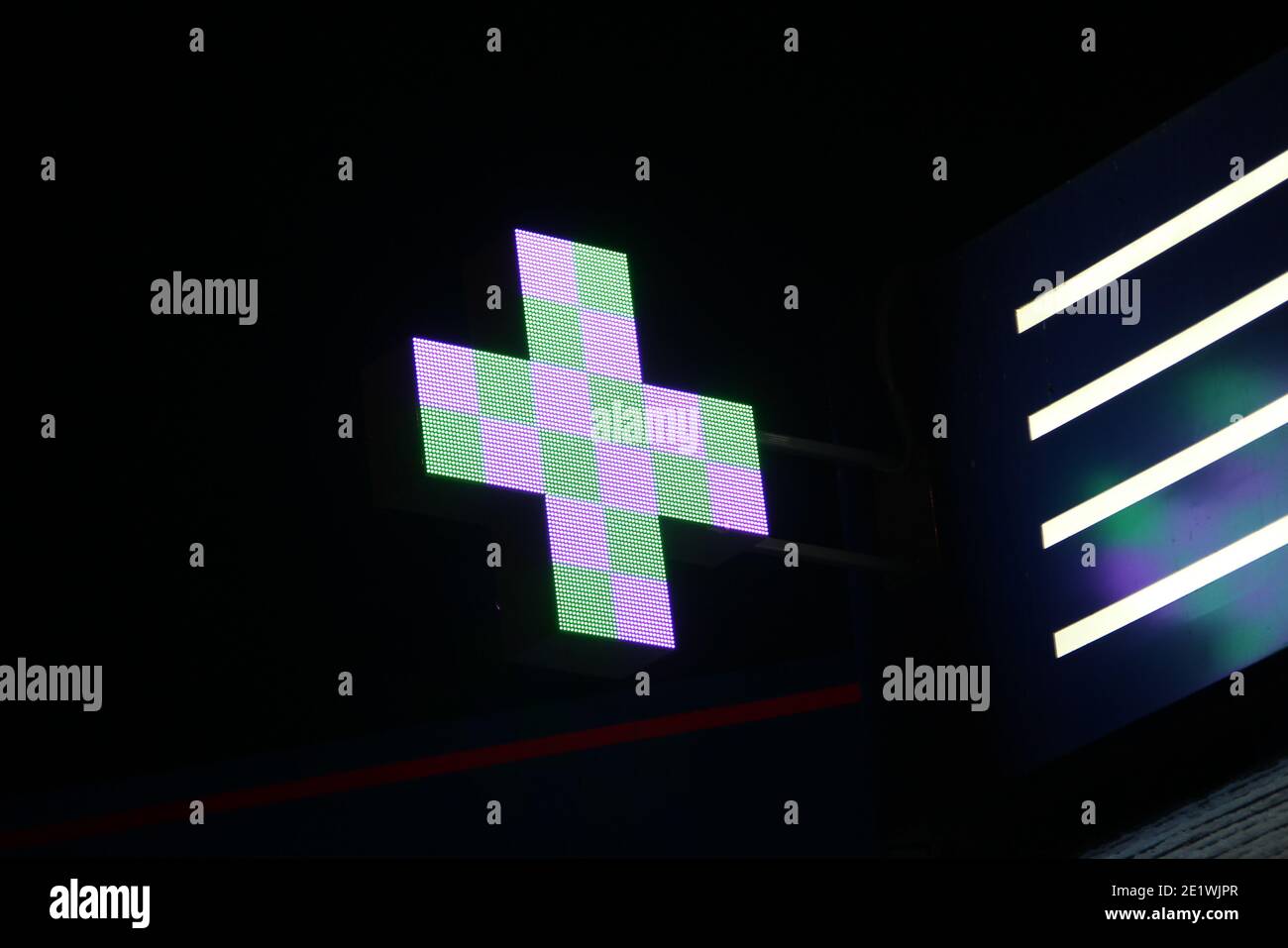 Glowing pixel cross of LED lamps on black background. Cross with a ...