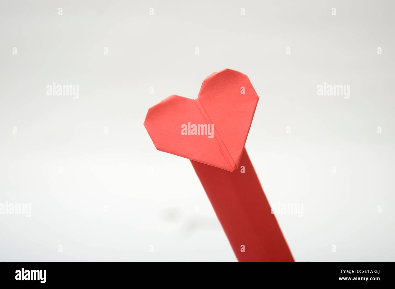 hand holding red bookmark, love symbol, in white background Stock Photo ...