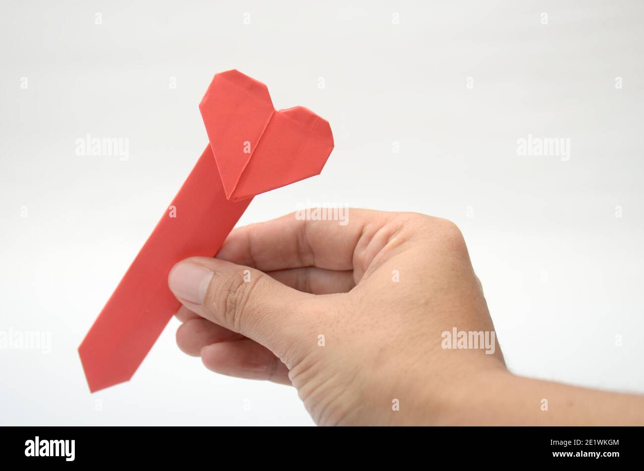 hand holding red bookmark, love symbol, in white background Stock Photo ...