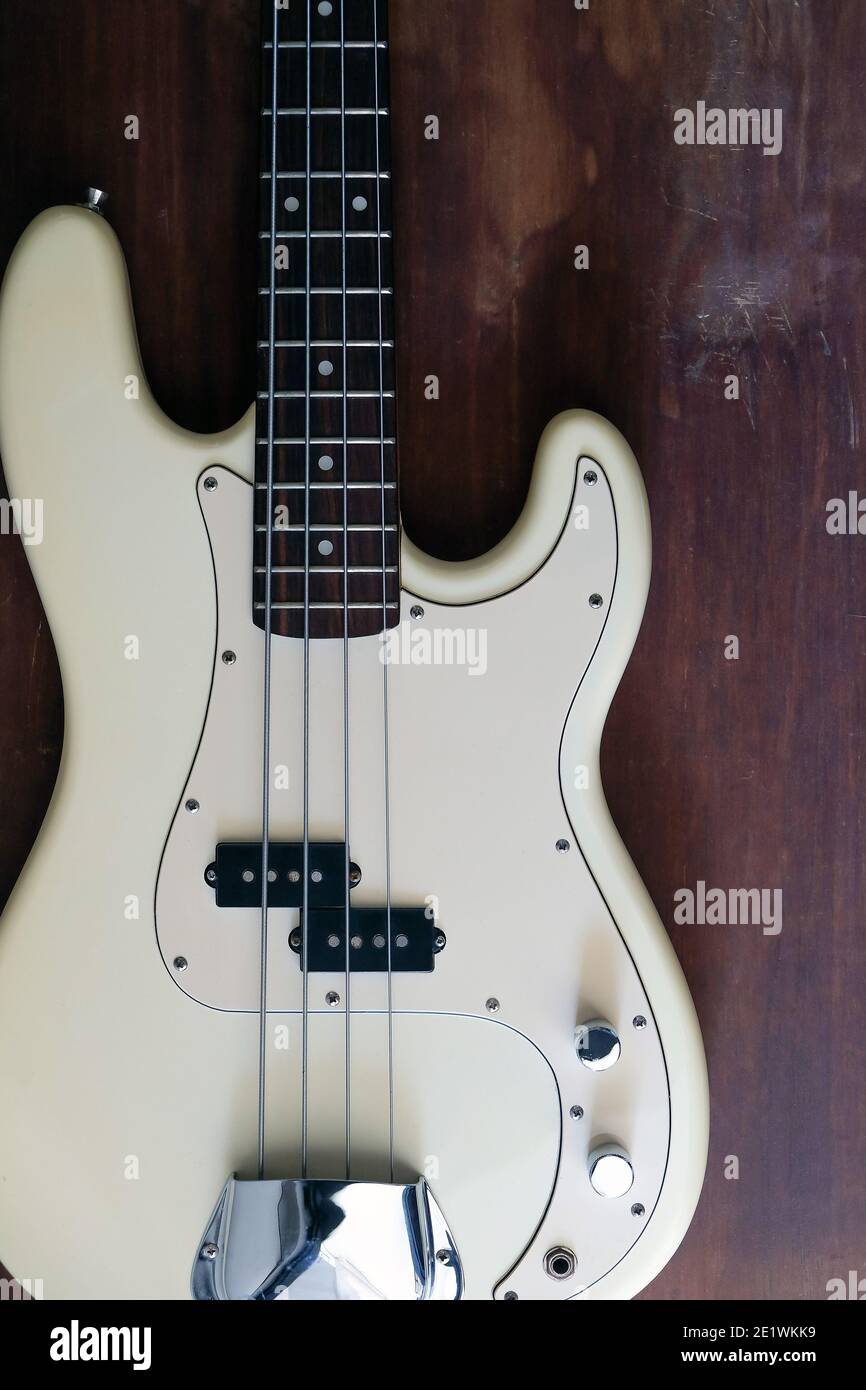 white electric bass guitar on wood background with copy space Stock ...