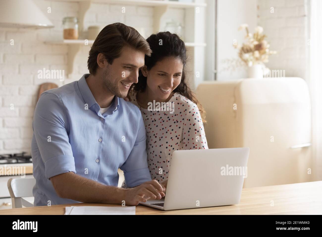 Caucasian couple using computer kitchen hi-res stock photography and ...