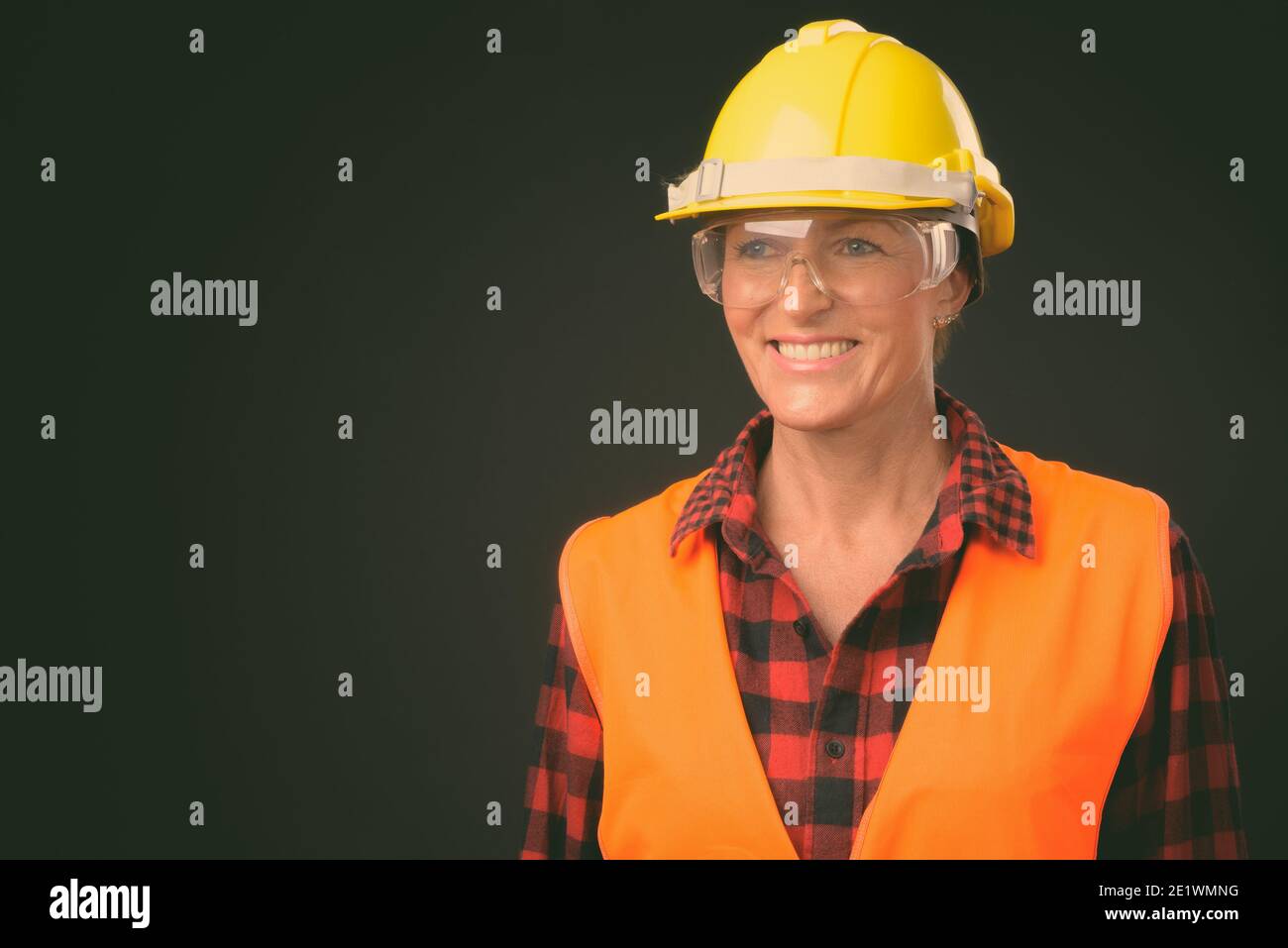 Mature beautiful woman construction worker with short hair against ...