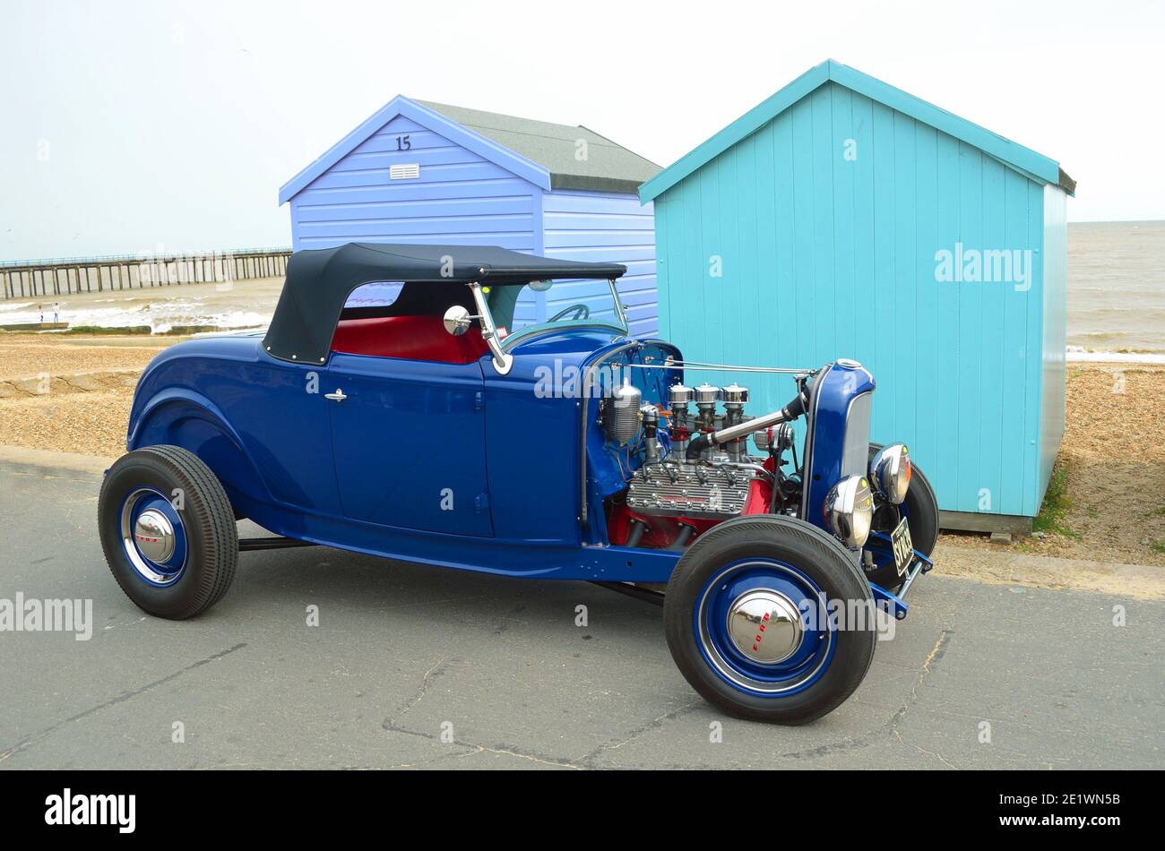 Classic Blue Hot rod parked in front of beach huts on seafront ...
