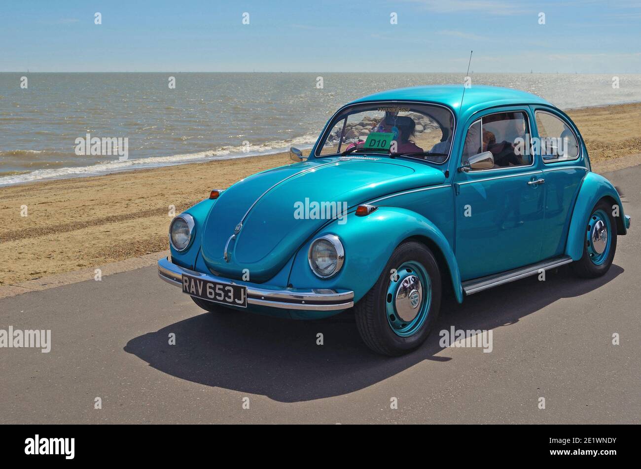 Classic Blue VW Beetle being driven along Felixstowe seafront promenade ...