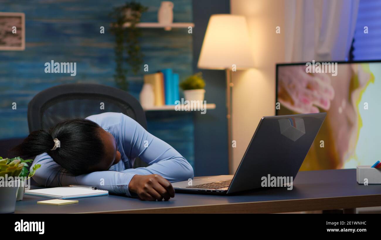 Exhausted overload black businesswoman falling asleep on desk with open ...