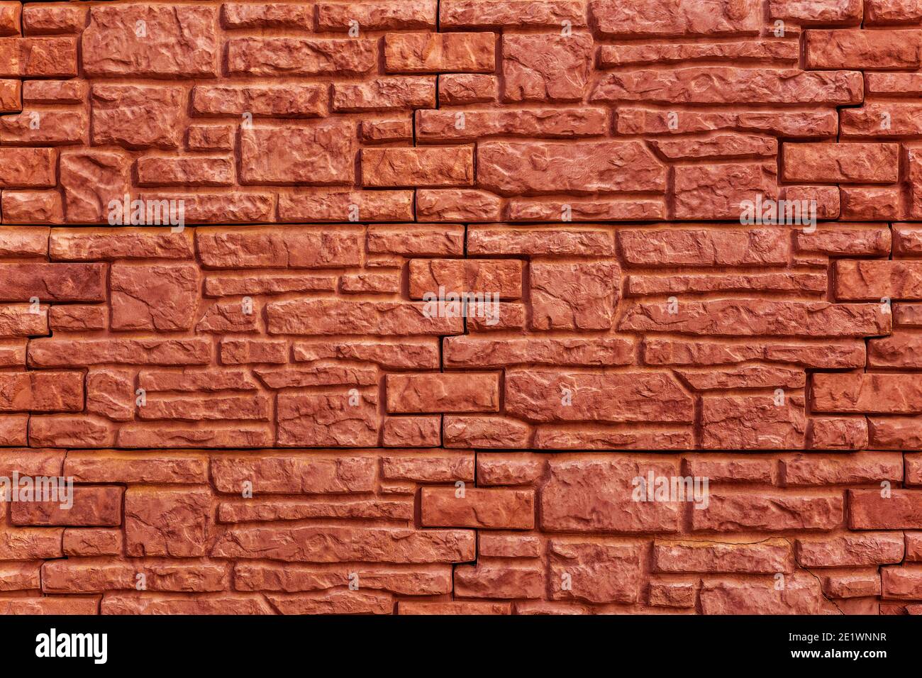 Background texture red, stone brick wall. Surface with a brickwork of ...